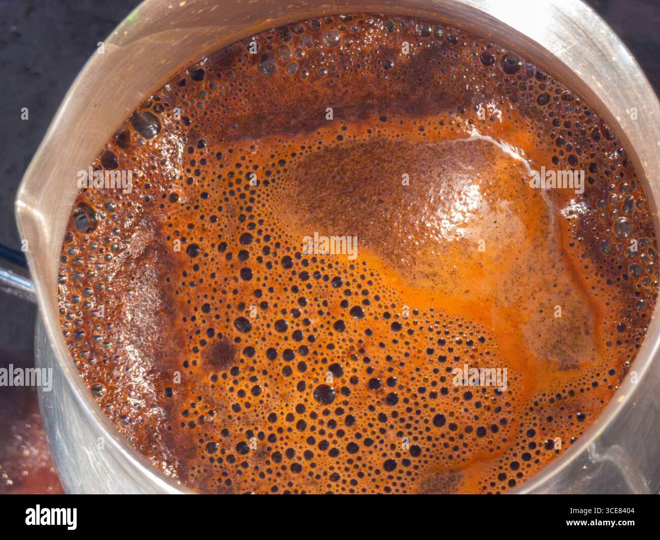 Brewing hot, aromatic Turkish coffee in a cezve, showcasing a rich ...