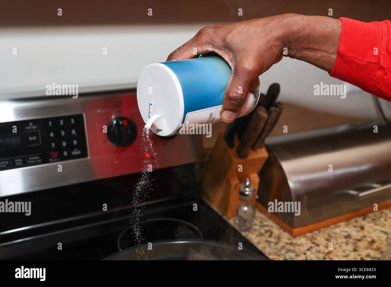 Black man pouring salt hi-res stock photography and images - Alamy