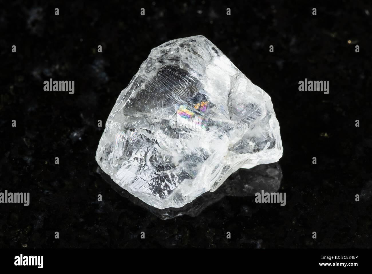 sample of raw goshenite colorless beryl mineral on black granite ...