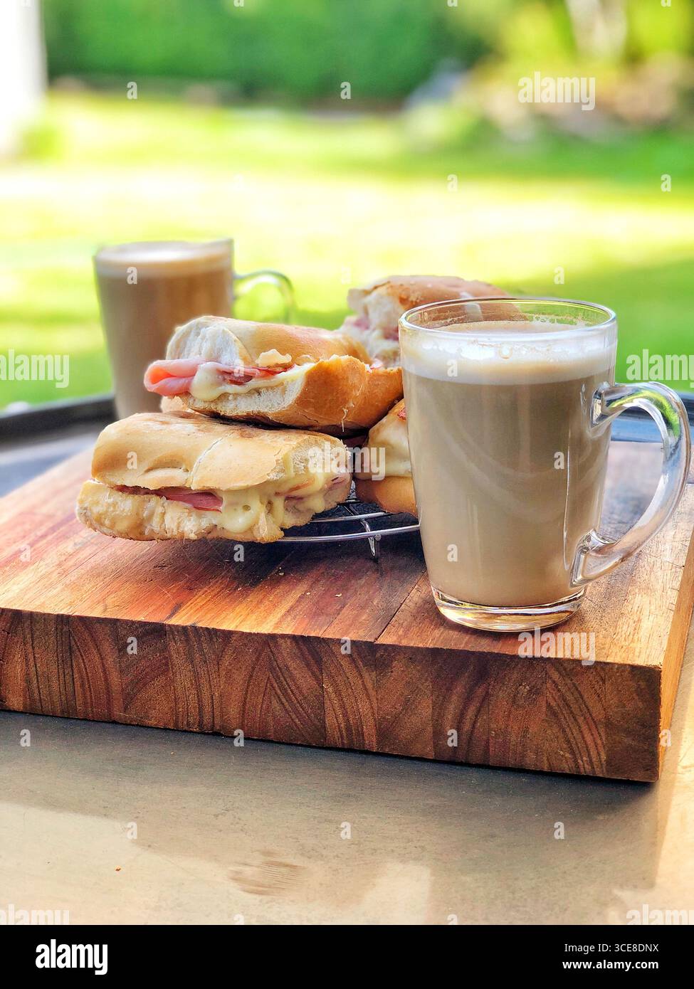 Toasted ham and cheese sandwiches with latte outdoors Stock Photo - Alamy