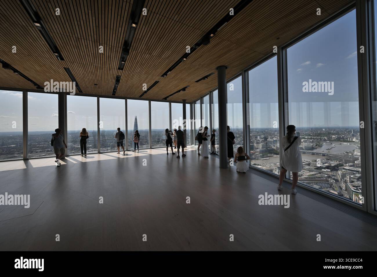 Visitors looking at the London skyline from The Lookout observation ...