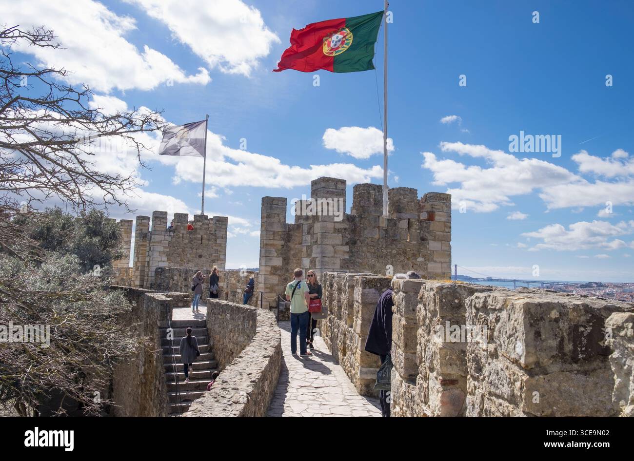 Portuguese flag flying above the hilltop Moorish castle Castelo de S ...