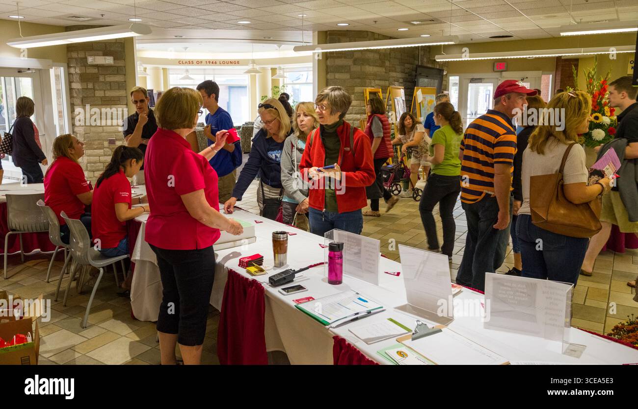 Adults at registration table for the WPI family weekend in the Rubin ...
