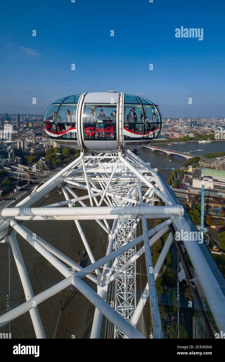 Passenger capsules of the Coca-Cola London Eye above the River Thames ...