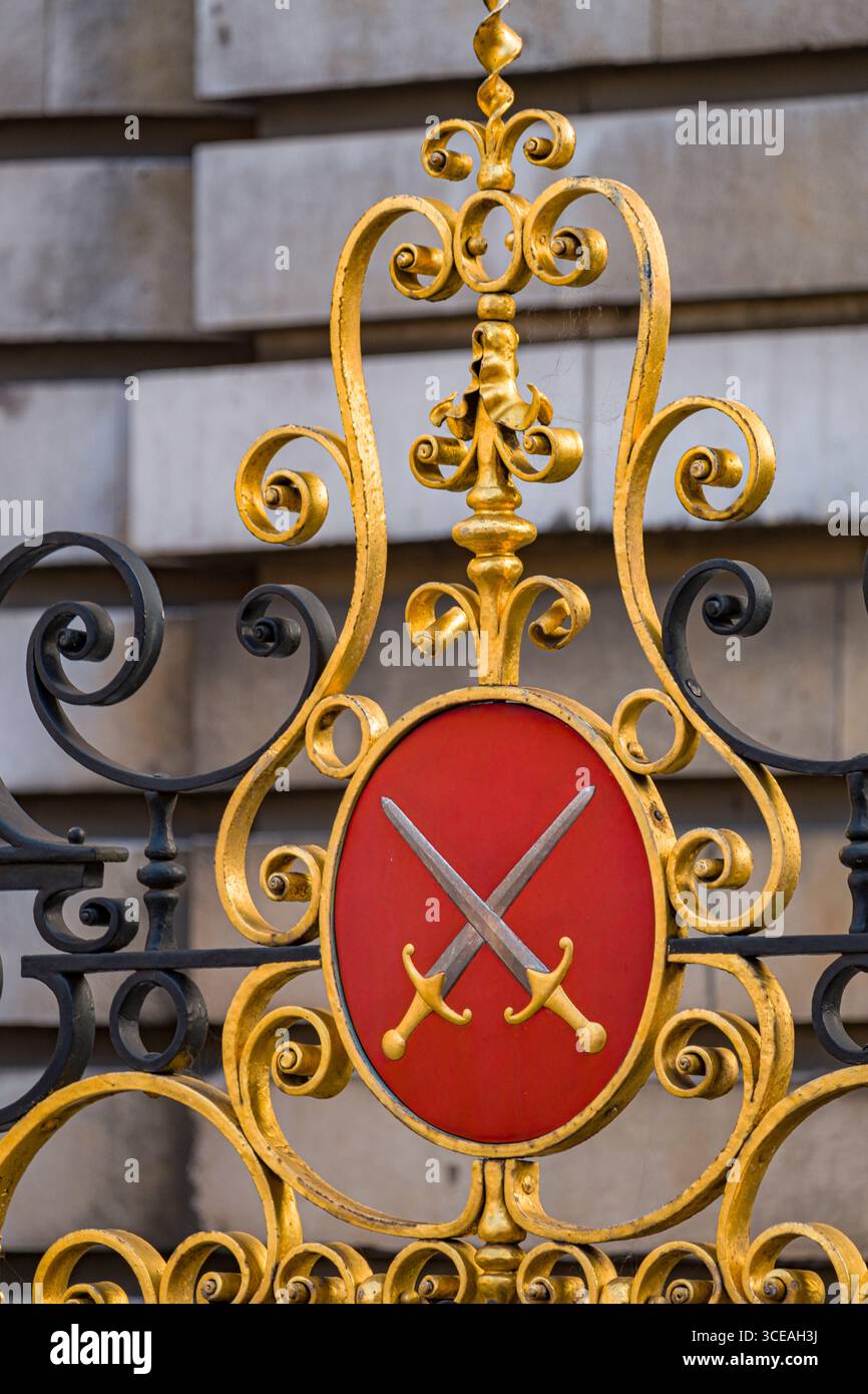Ornate wrought iron fence with crossed swords on a red field, City of ...