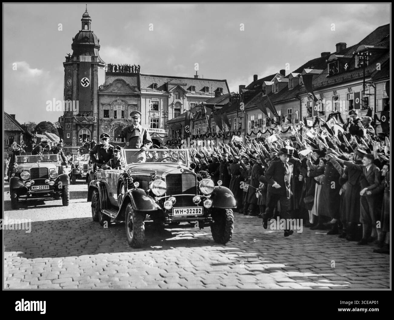 Adolf Hitler is enthusiastically welcomed with swastika flags and Hiter ...