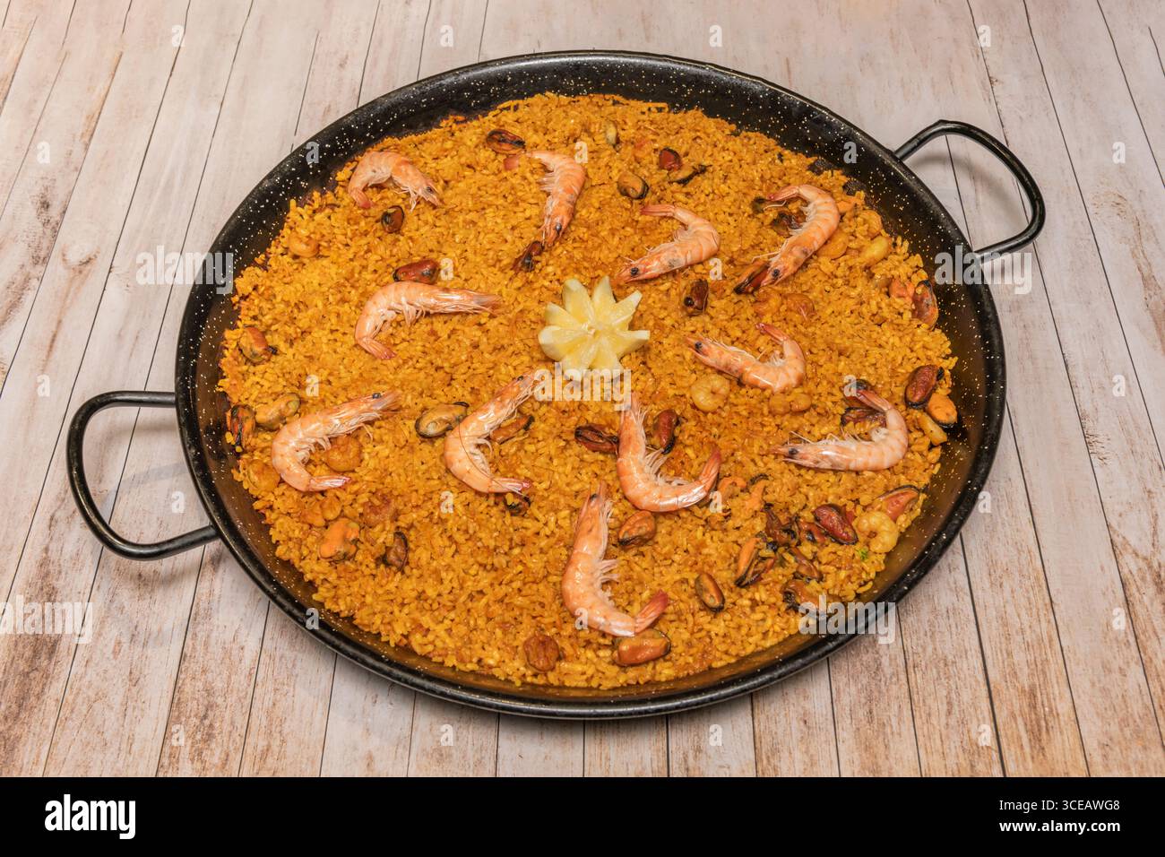 Seafood paella with peeled shrimp, clams, and mussels, where saffron ...