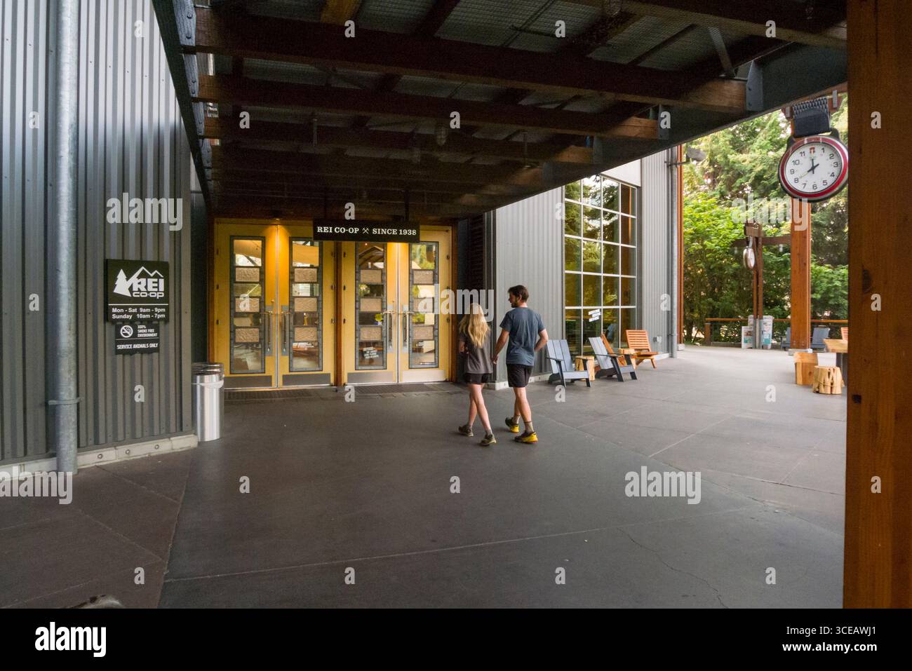 Young couple walking toward entrance to REI flagship store in Seattle ...