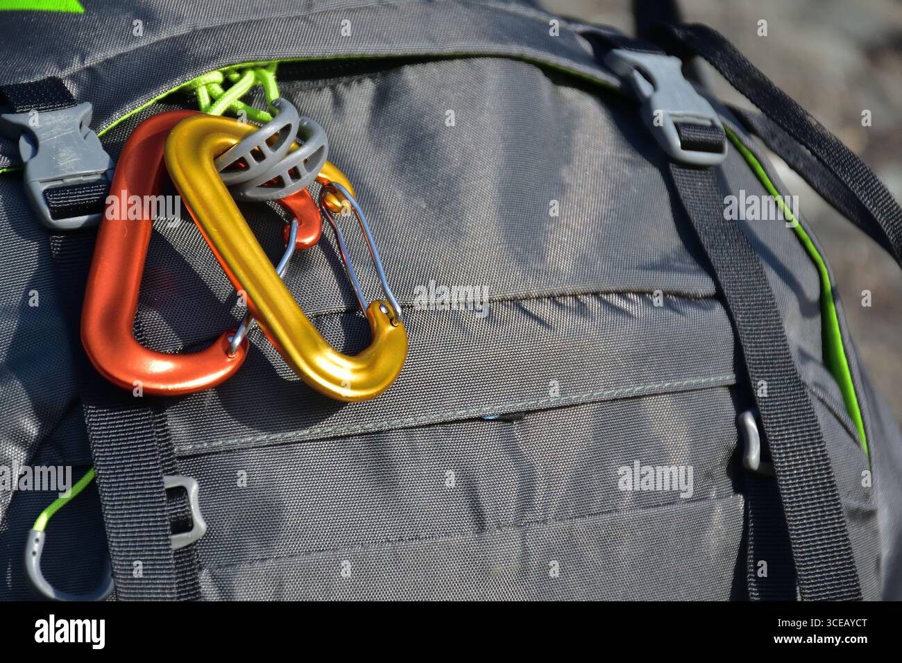 Yellow and orange carabiners on a backpack. Hiking backpack attachment ...