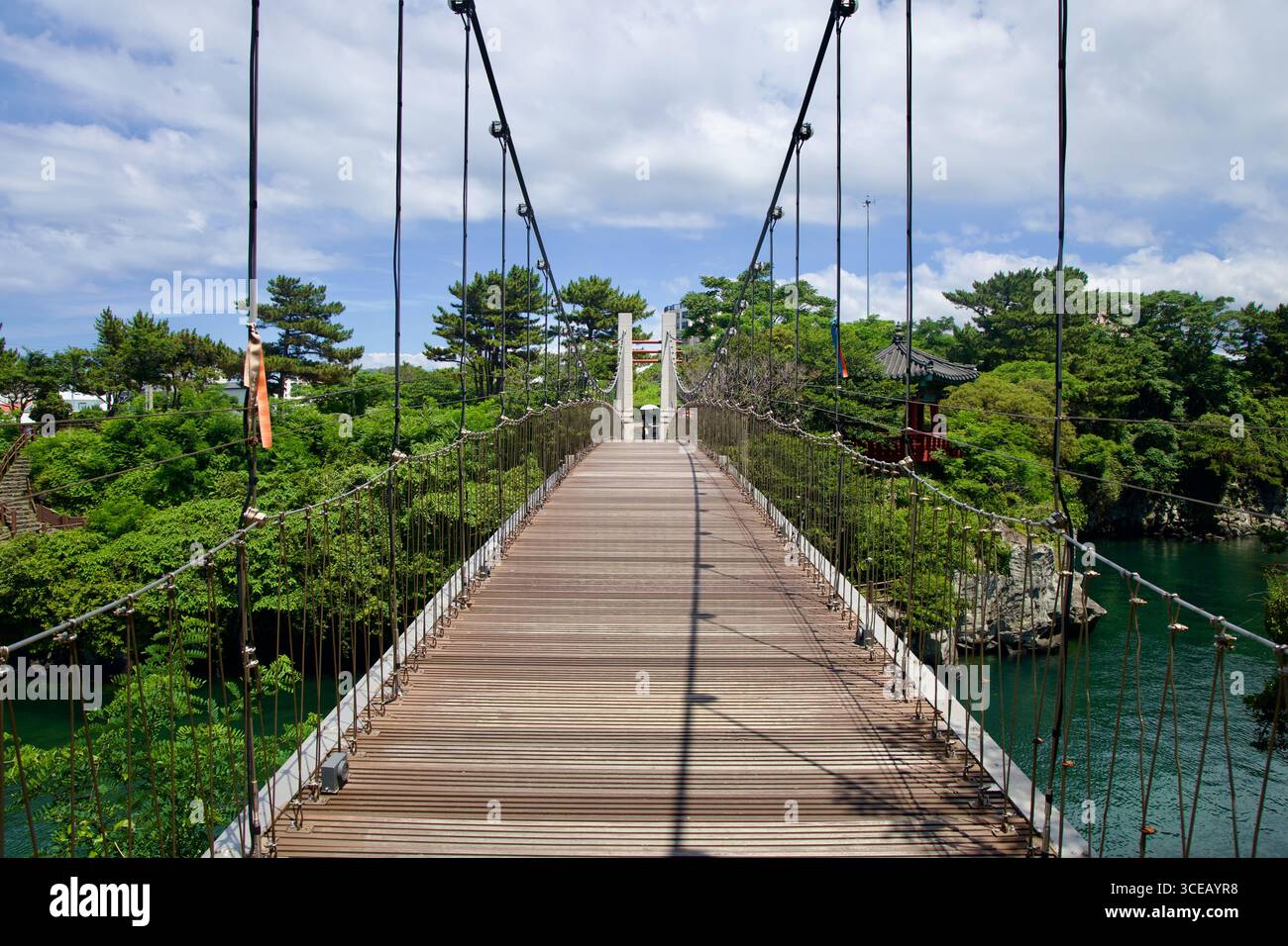 A straight‑on view along the wooden Yongyeon Cloud Bridge shows its ...