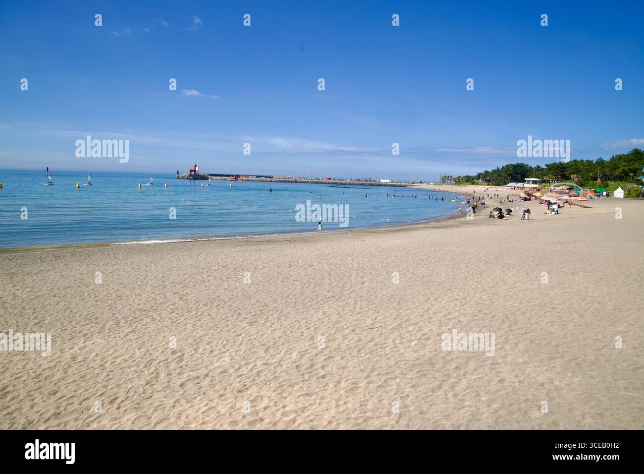 A wide sweep of pale sand borders the calm cove at Iho Tewoo Beach ...