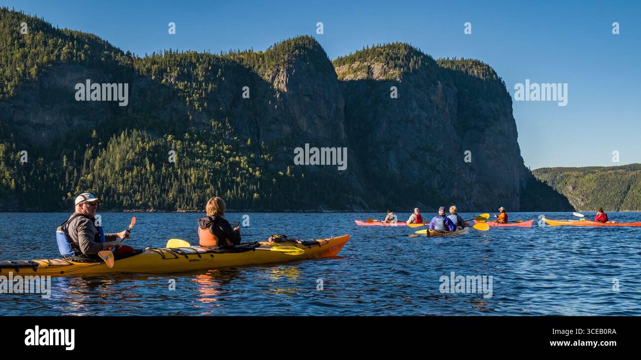Group of people in plastic tandem kayaks kayaking on Baie Éternité ...