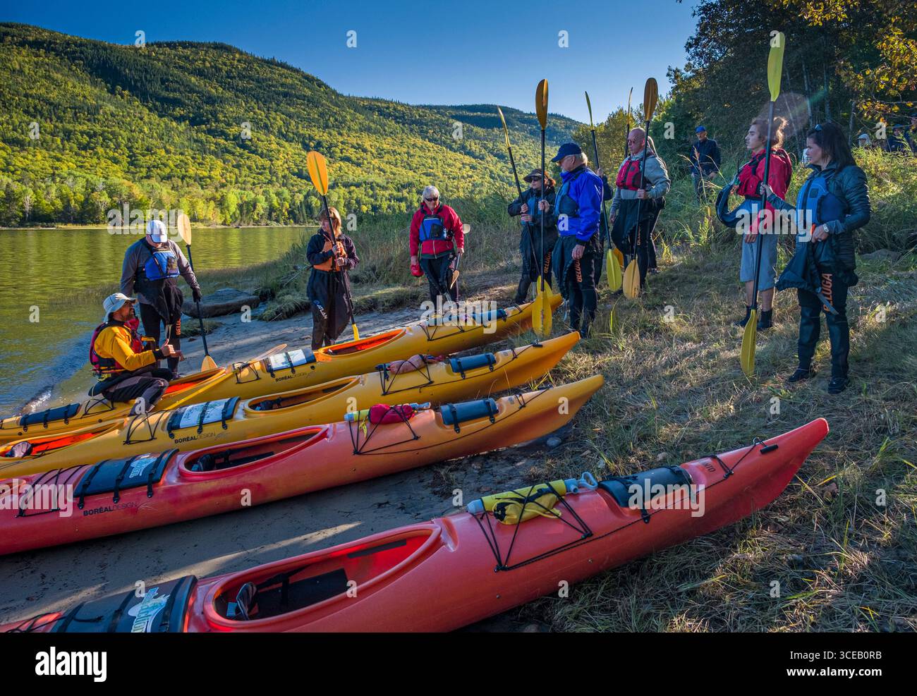 Male kayak guide giving instruction to a group of tourist before a ...