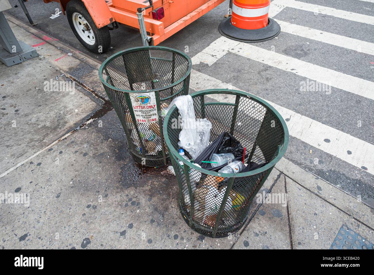 Metal trash cans on dirty sidewalk, W 57th St., New York, New York, USA ...