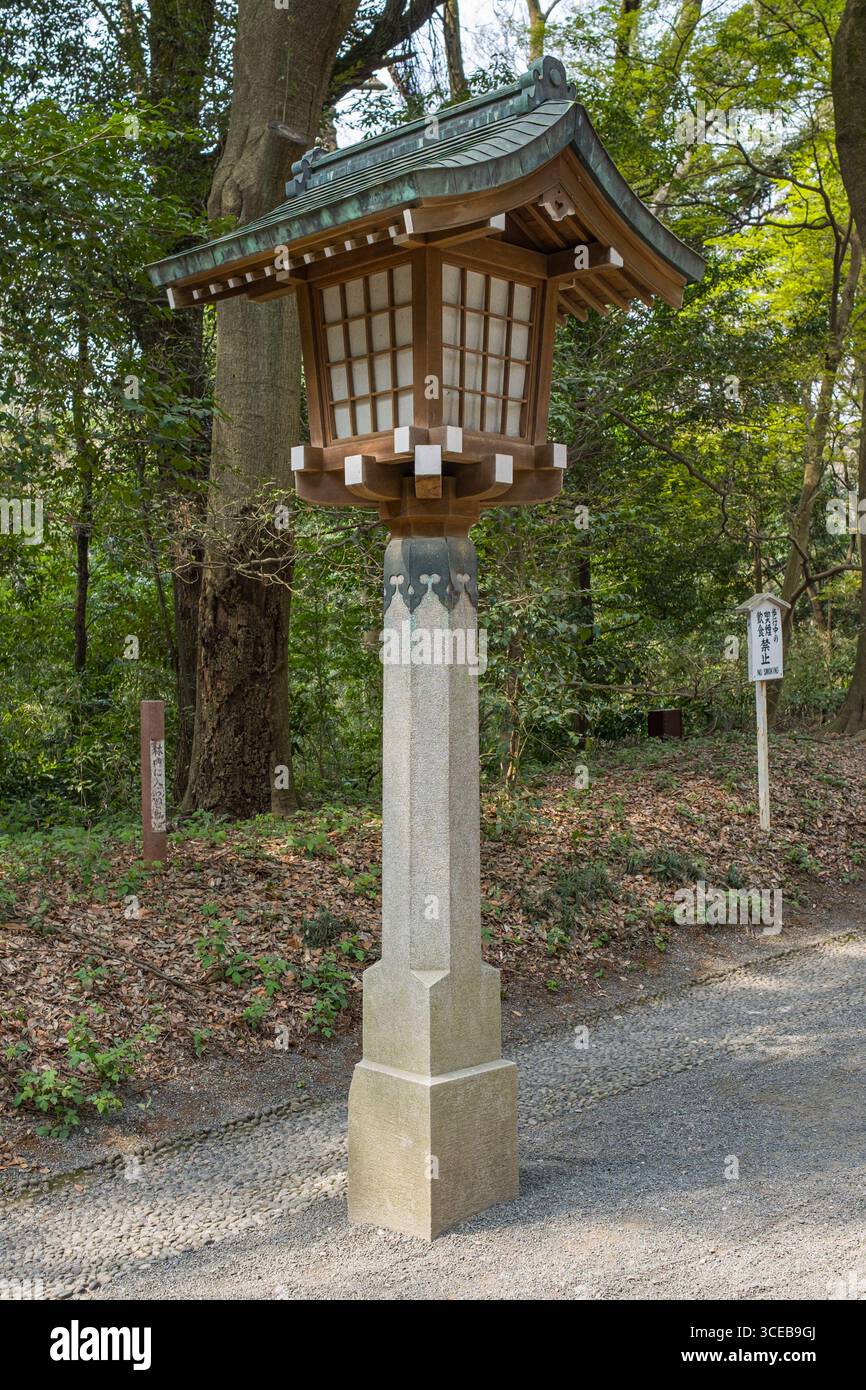 Ornate lantern on stone pedestal in the Meiji Jingu Shinto shrine ...