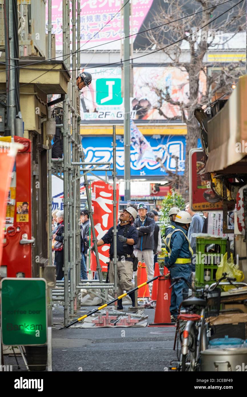 Japanese construction workers building scaffolding in Akihabara ...