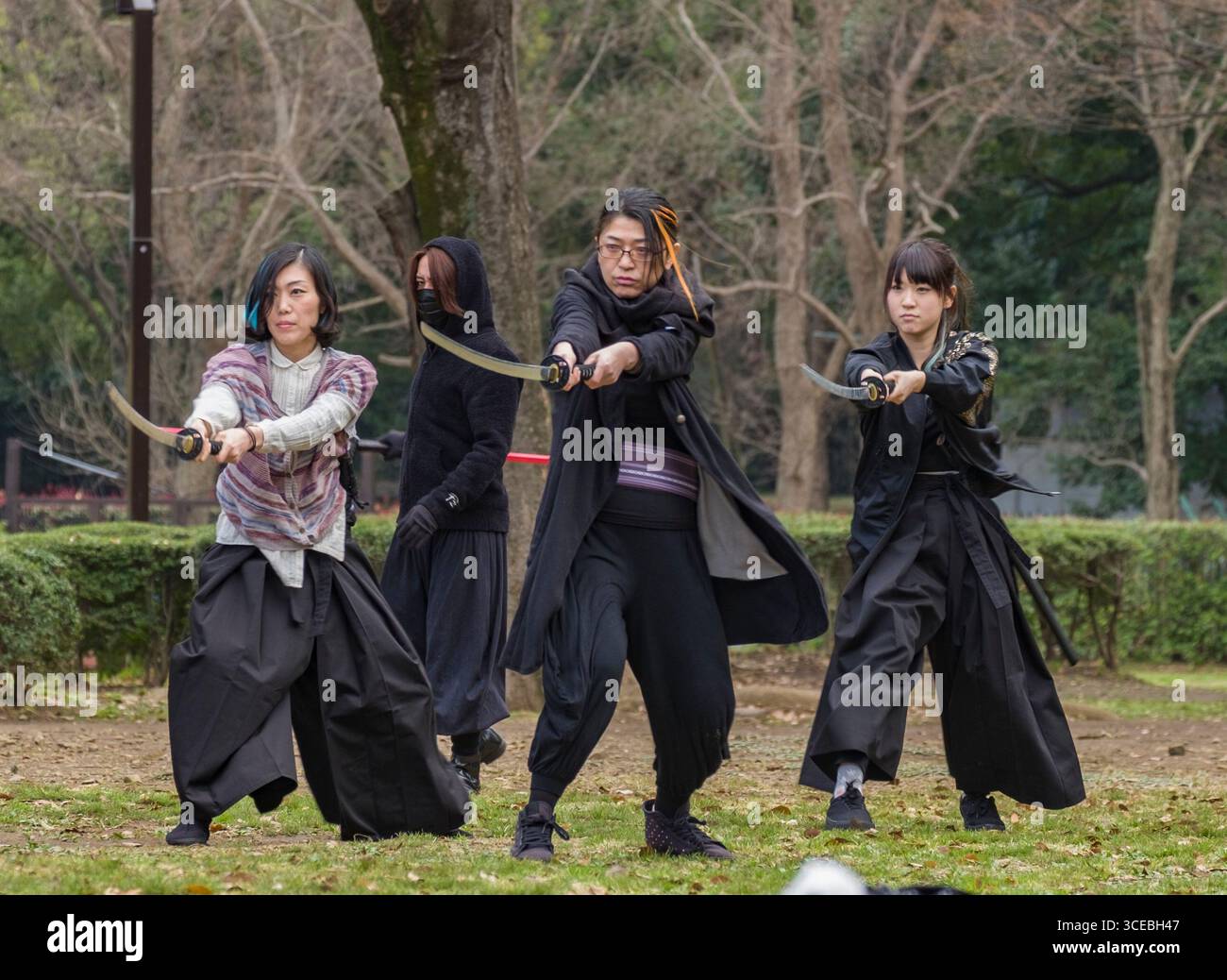 Group of Japanese women practicing choreographed sword fighting in ...