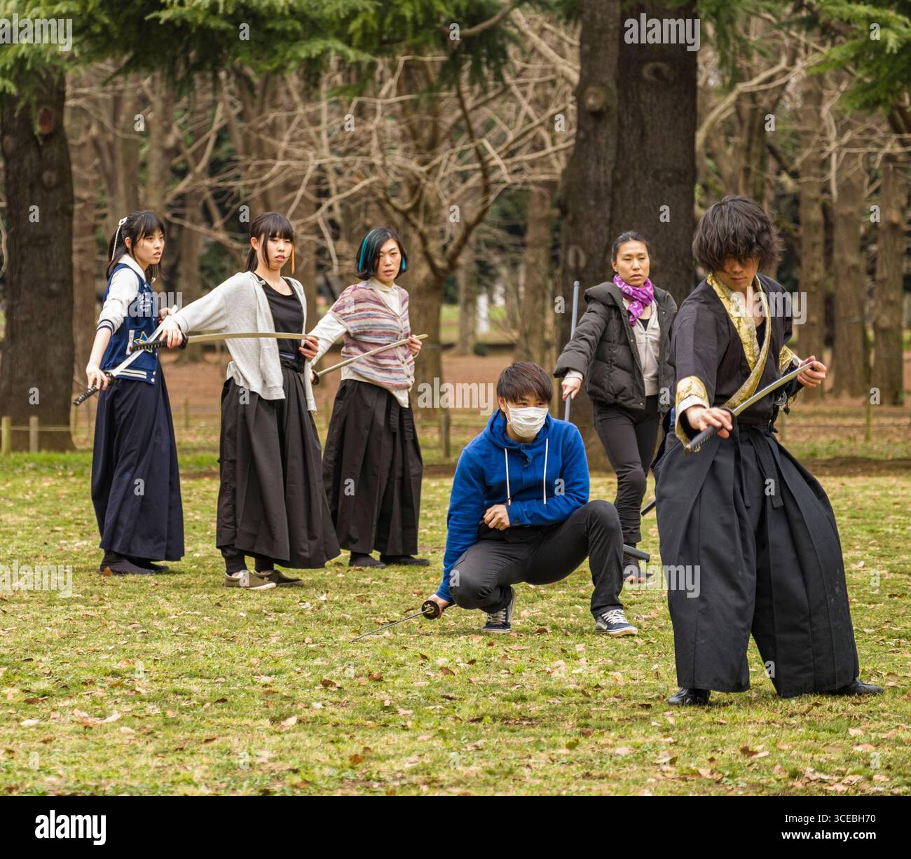 Group of Japanese people practicing choreographed sword fighting in ...