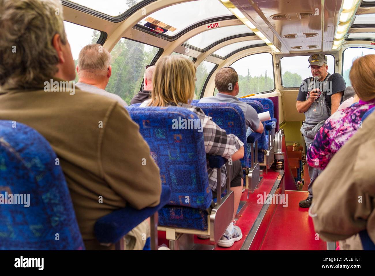 Conductor guide speaking to passenger in the observation car on the ...