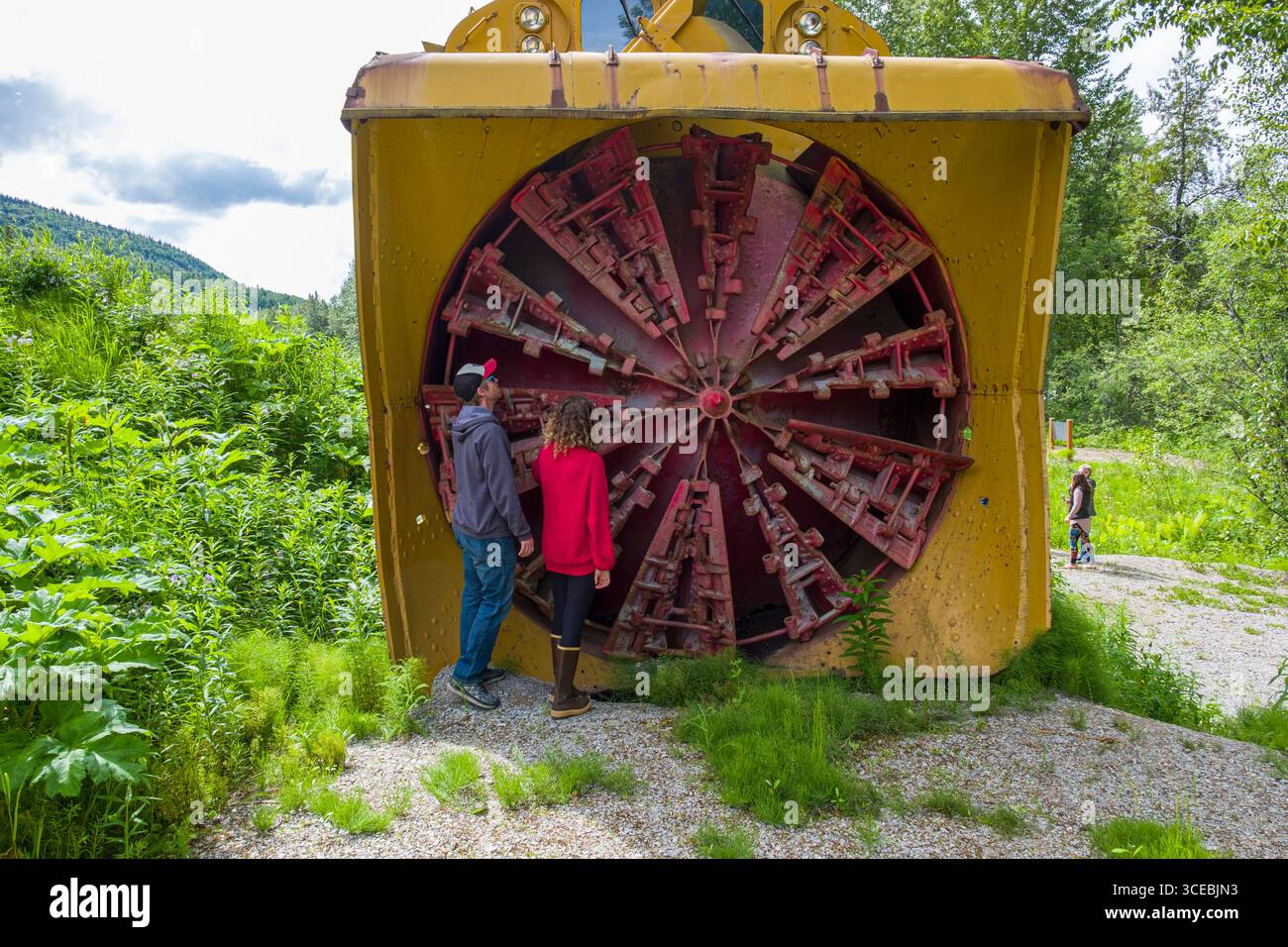 People standing in front of large Alaska Railroad derelict rotary ...