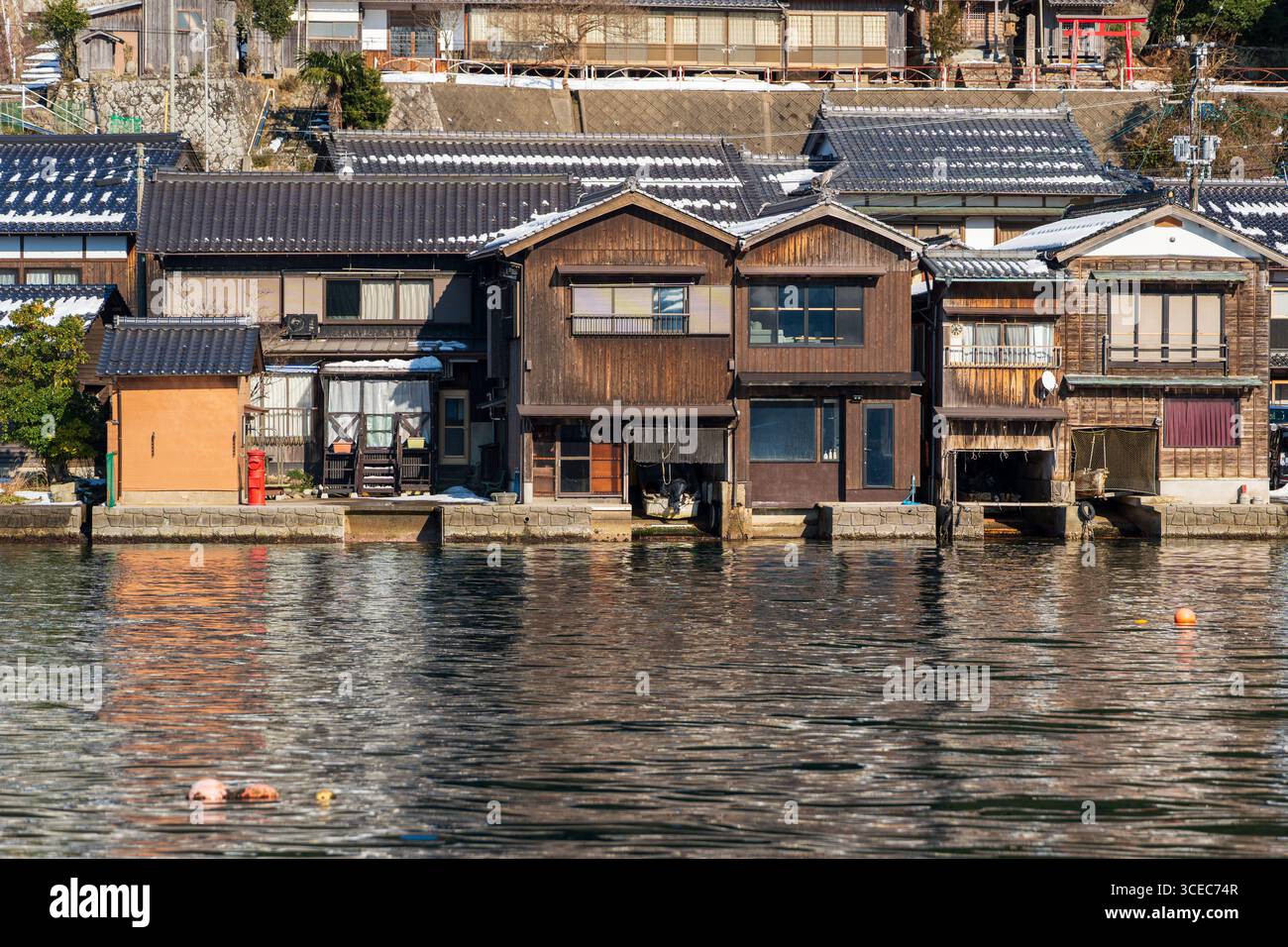 A row of traditional Funaya boathouses in the fishing village of Ine ...