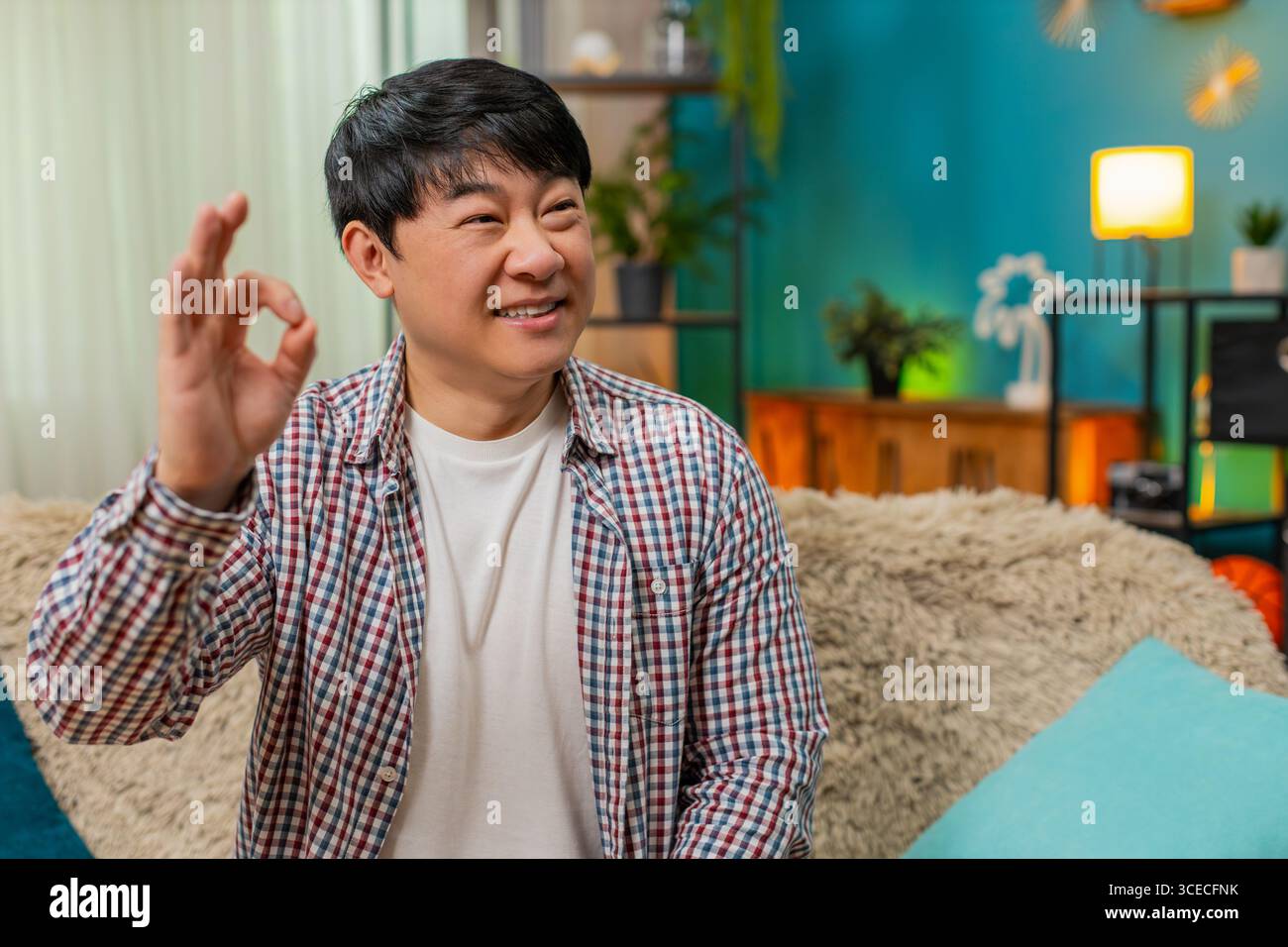Asian man smiles shows thumbs hi-res stock photography and images - Alamy