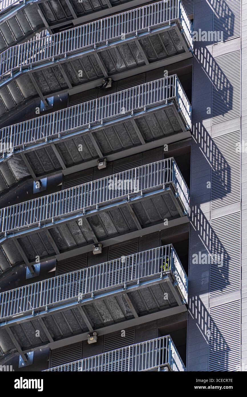 A series of sleek metal staircases adorn the exterior of an urban high ...