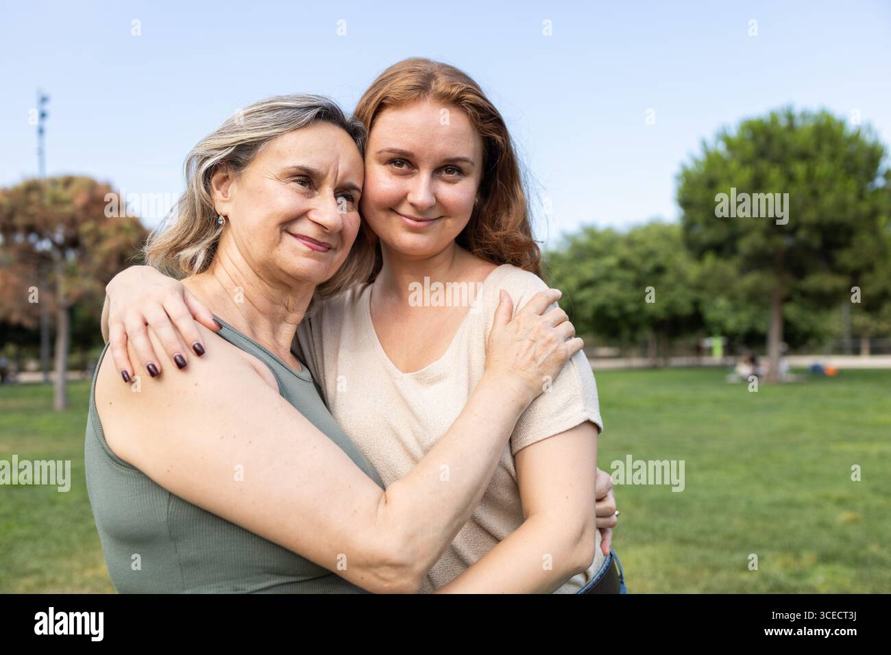 A warm moment captured between a mother and daughter embracing in a ...