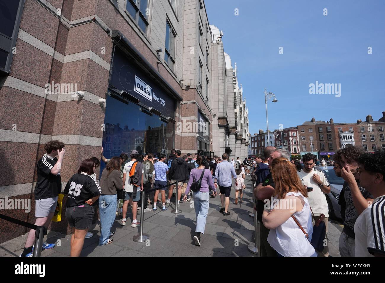 Fans queue outside the Oasis merchandise store on St Stephen's Green in ...