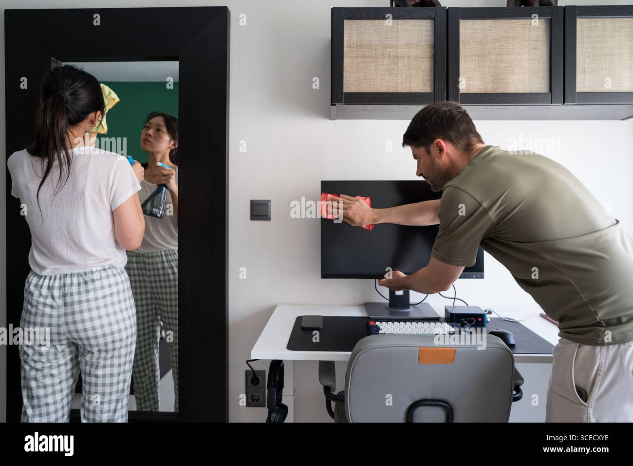 A contemporary couple engaged in household chores, exemplifying shared ...