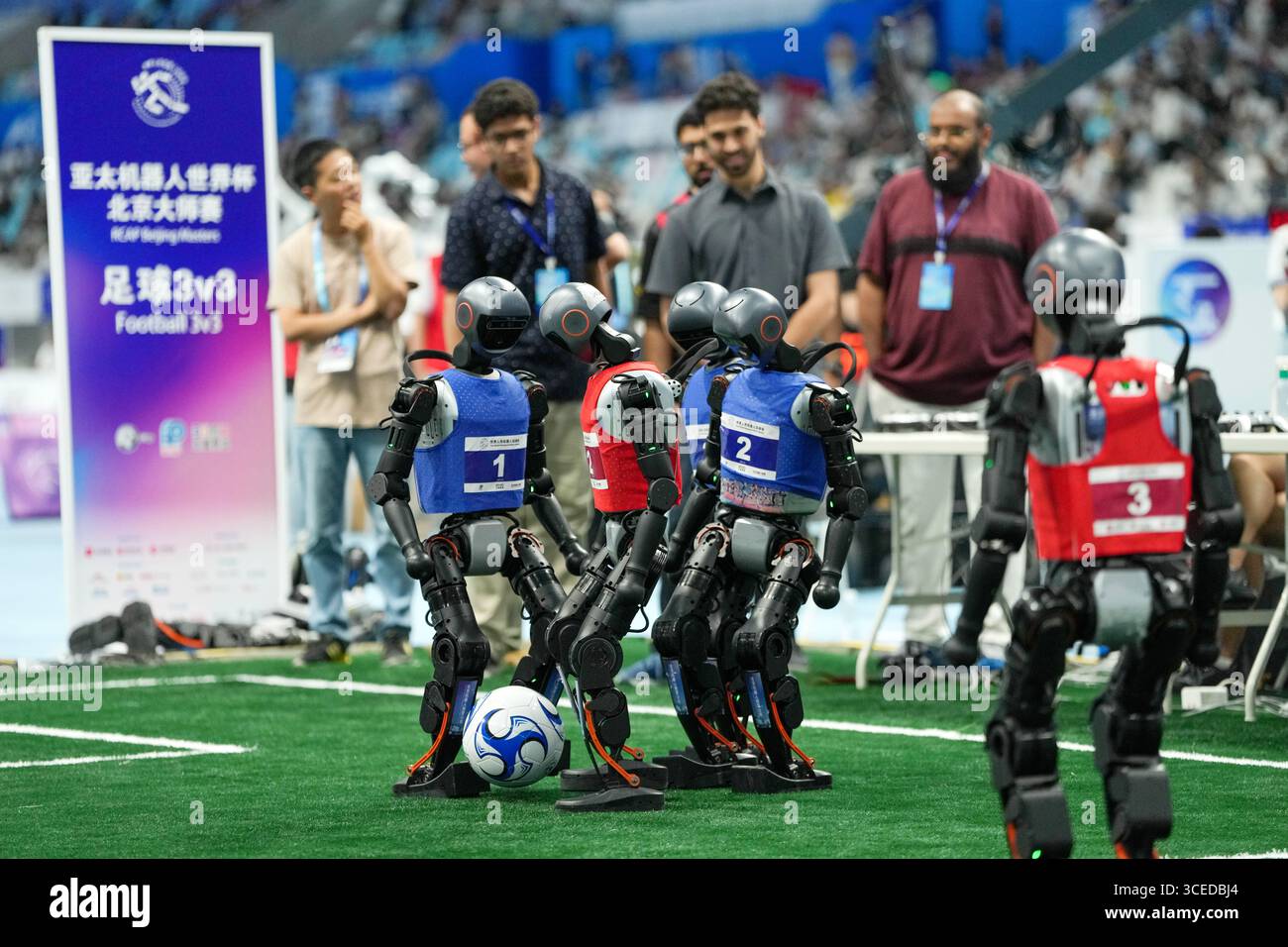 Beijing, China. 15th Aug, 2025. Humanoid robots compete during a 3V3 ...