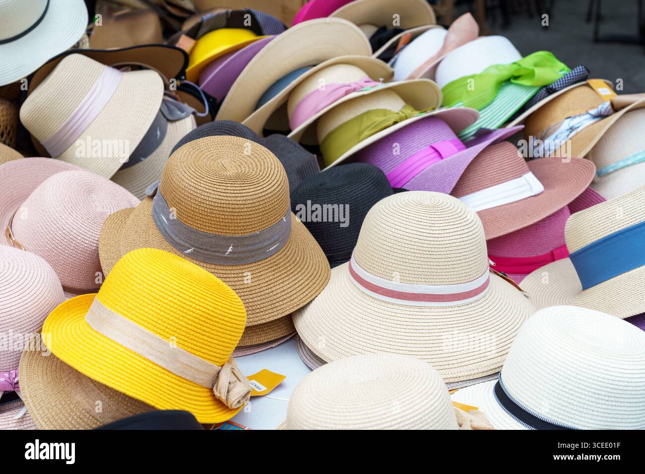 A colorful assortment of wide-brimmed hats is displayed for sale at a ...