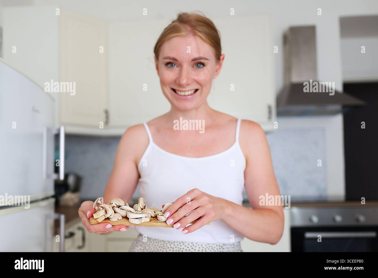 Chef woman cutting fresh champignon hi-res stock photography and images ...