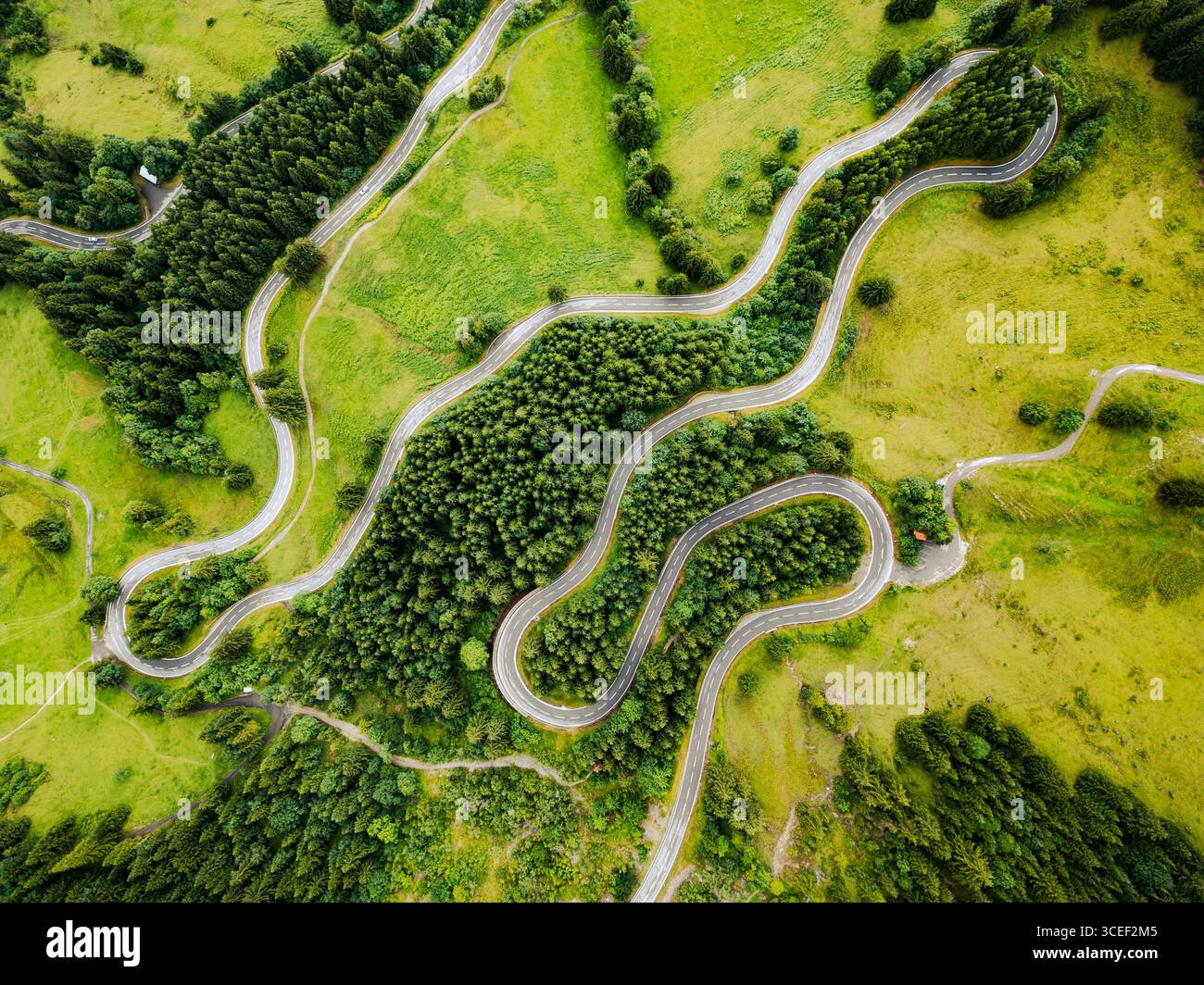 Aerial view captures the serpentine curves of asphalt roads weaving ...