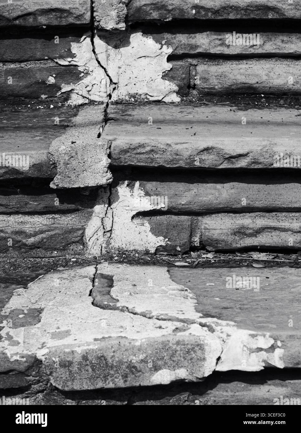 Black and white image of cement steps in disrepair cracking and ...