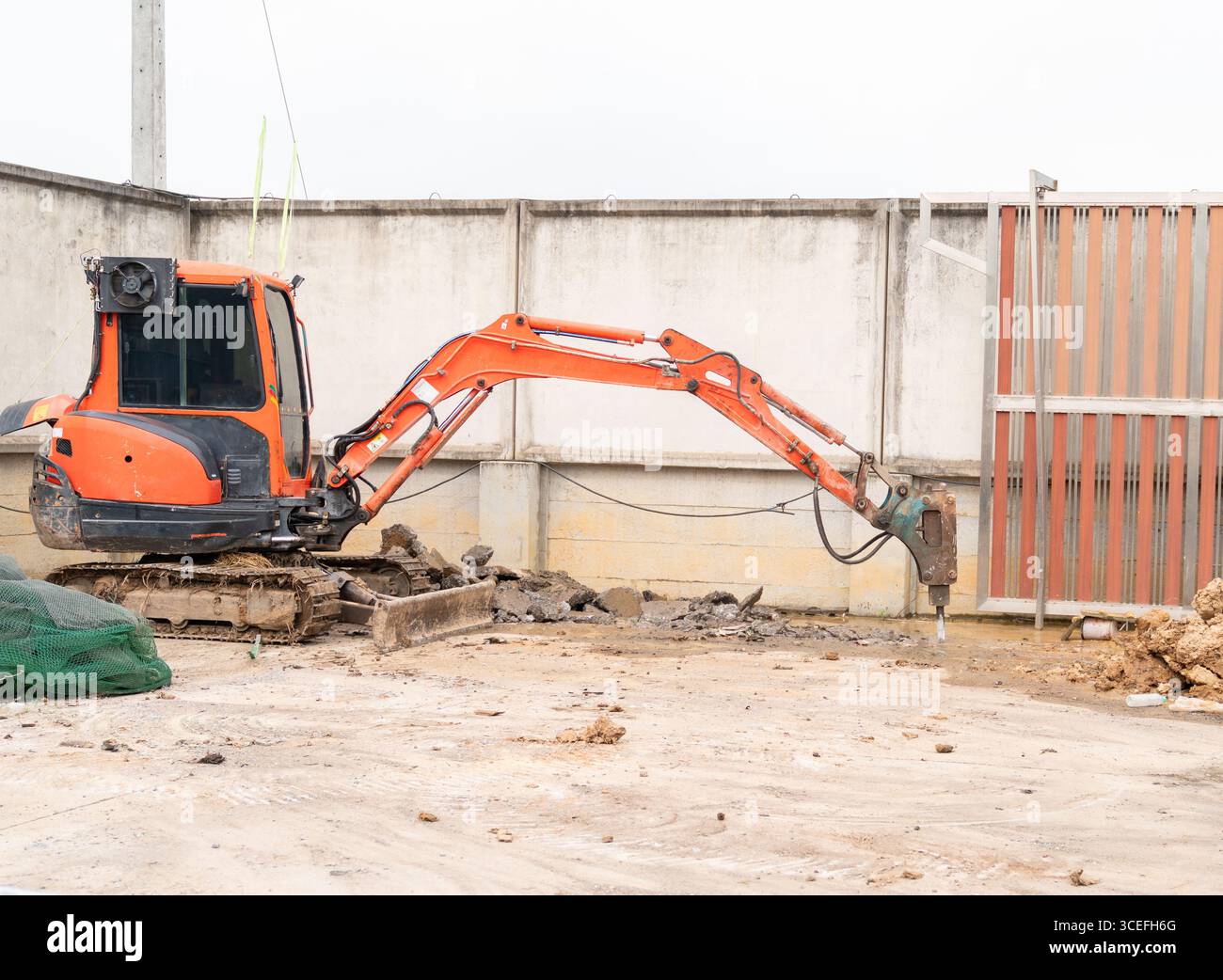 Industrial equipment with an orange body and long arm operating against ...