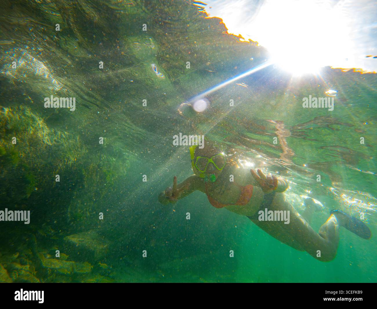 A joyful snorkeler exploring the clear waters of San Andres Island ...