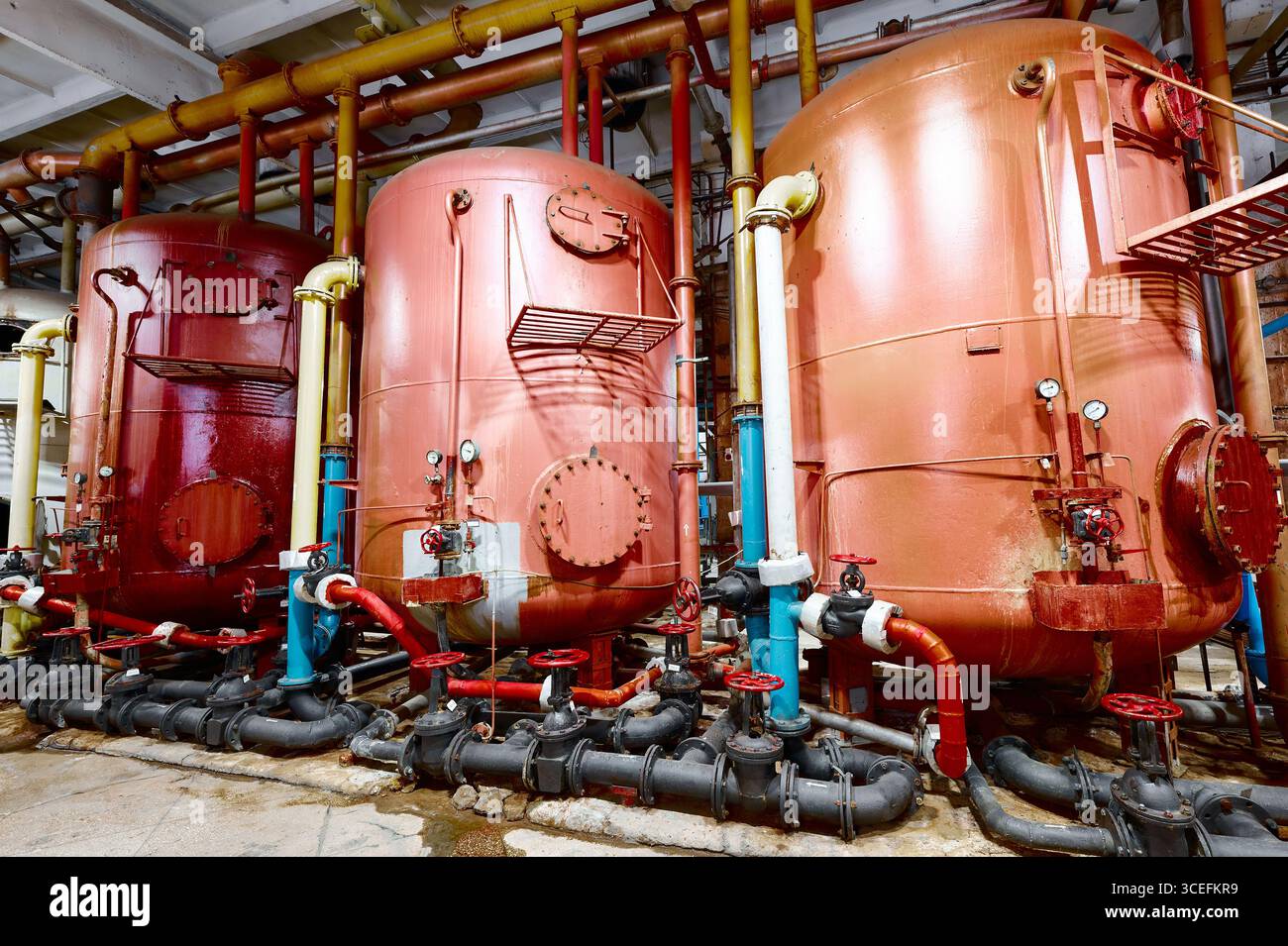 Industrial tanks and piping system in a facility showing the inner ...