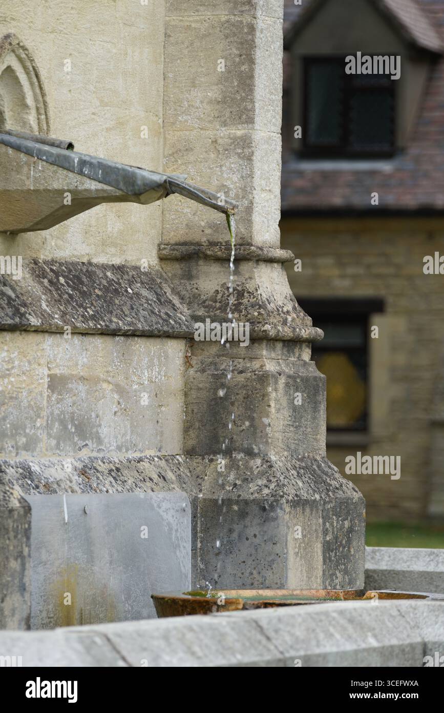 Historic Stone Water Spout Dripping Fluid Outside a Traditional ...