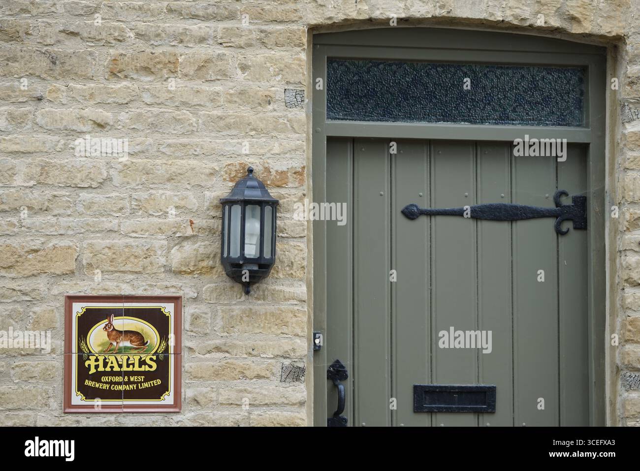 Exterior of a Stone Building With Decorative Sign and Lantern. Chipping ...