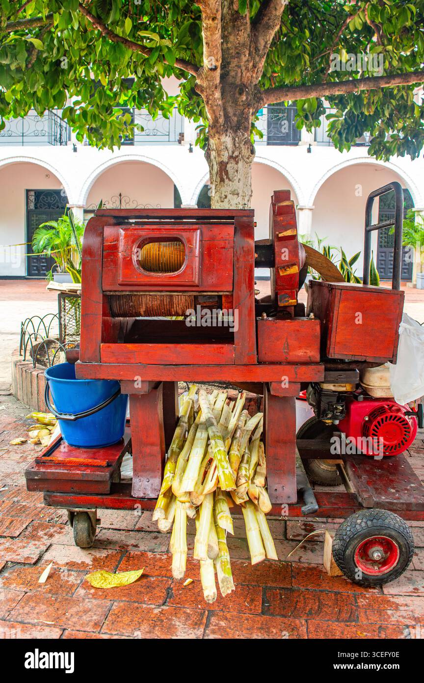 A vibrant scene showcasing a traditional sugarcane press cart amidst ...