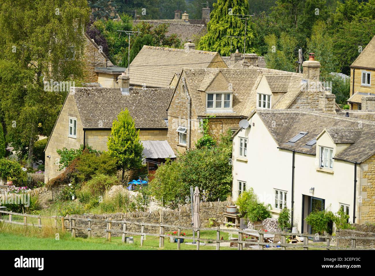 Idyllic English Village Scene with Traditional Cottages and Lush Green ...