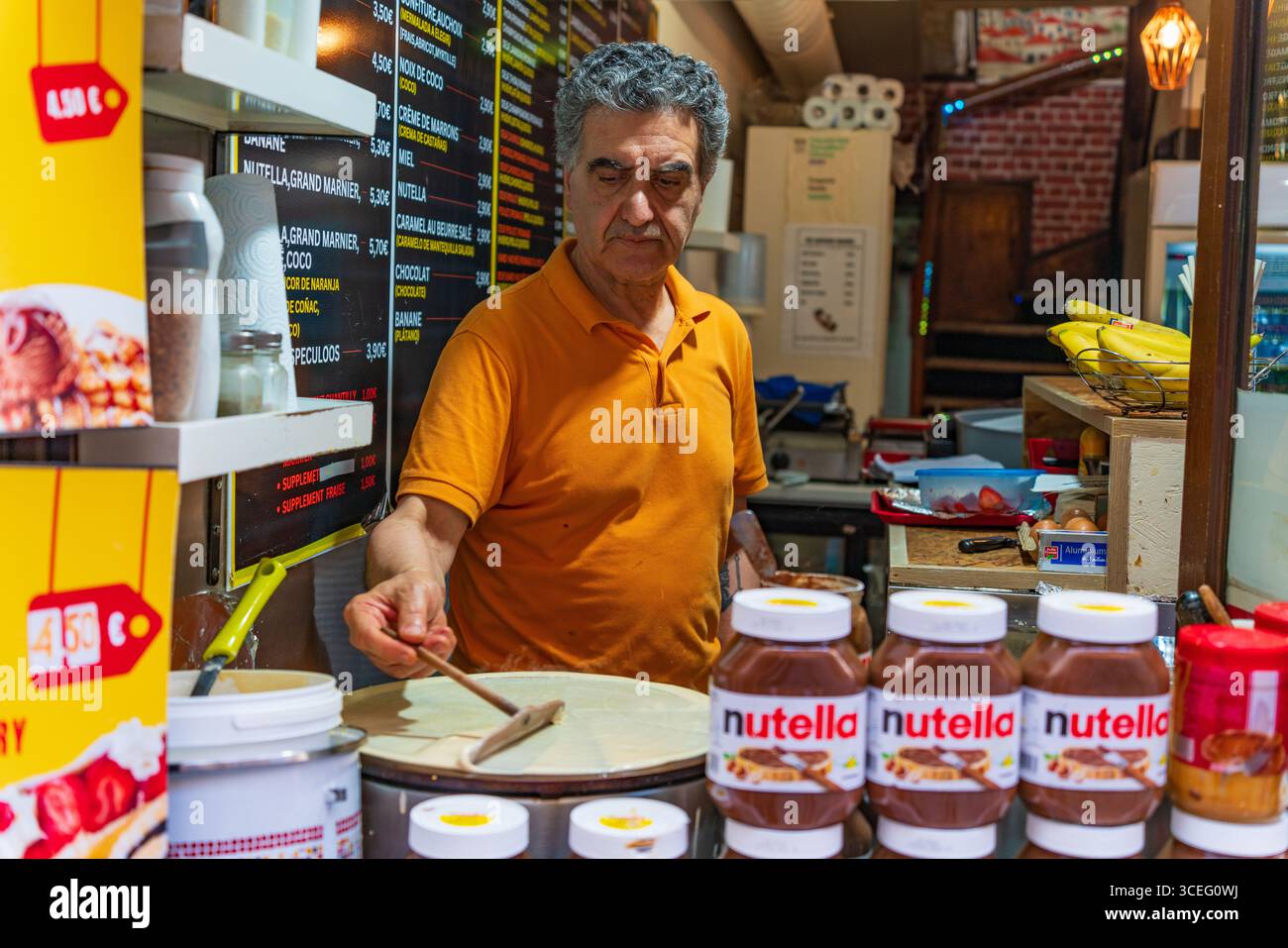 A man making crepe in a crepe shop in Paris, France Stock Photo - Alamy