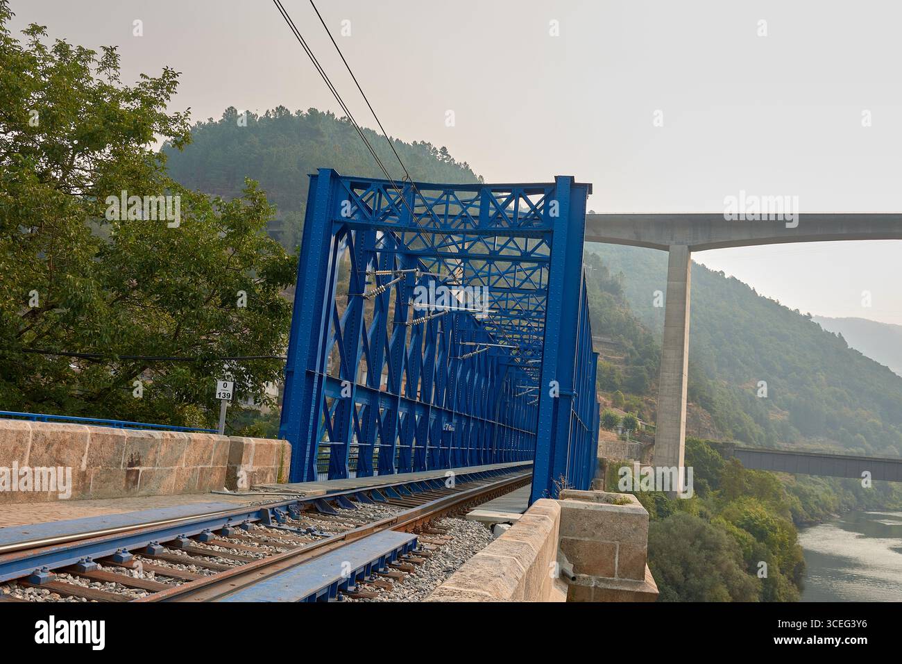 A railway bridge Blue-painted iron in Peares, Galicia, frames the ...