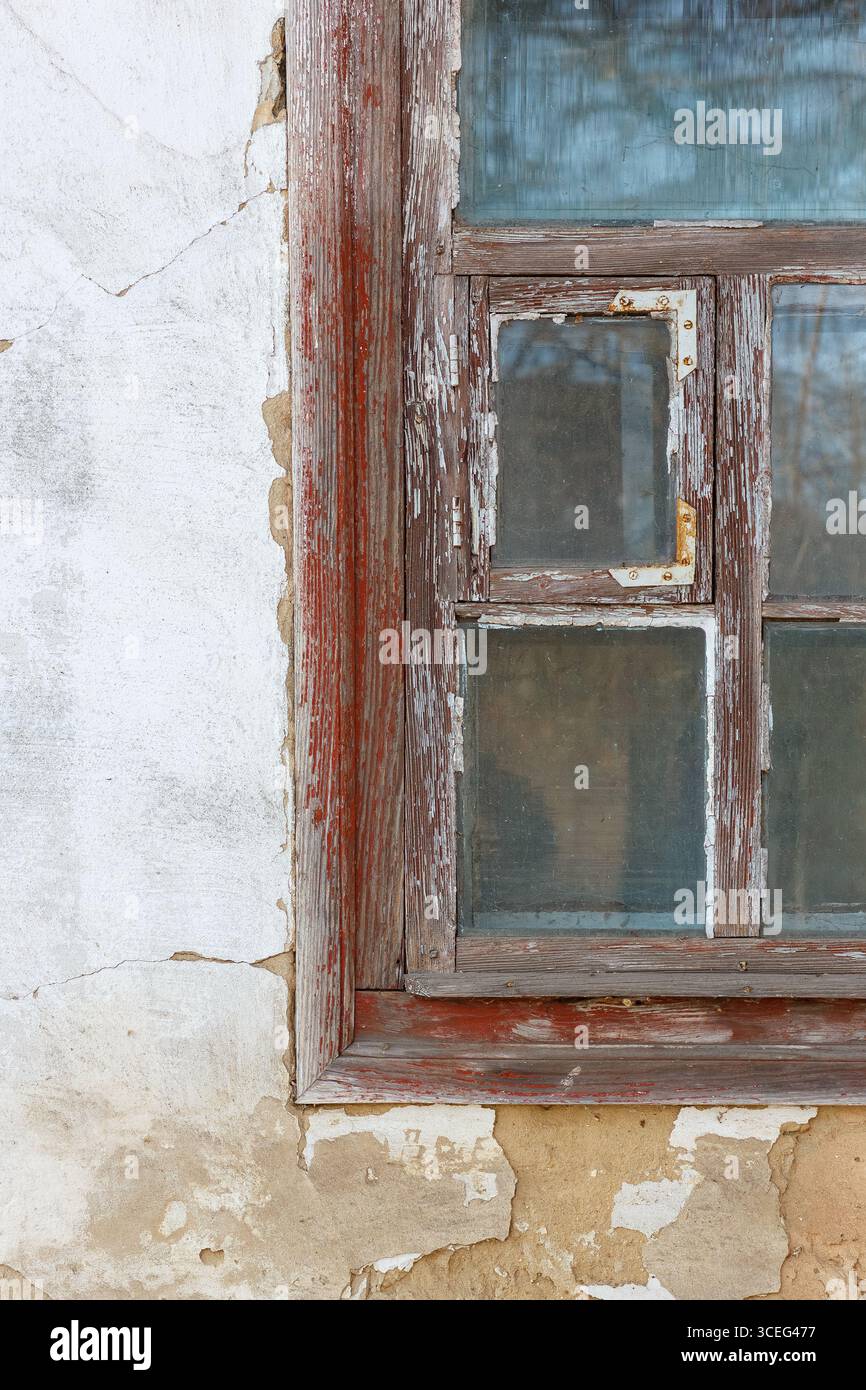 Detailed view of a rustic, peeling wooden window frame with cracked ...