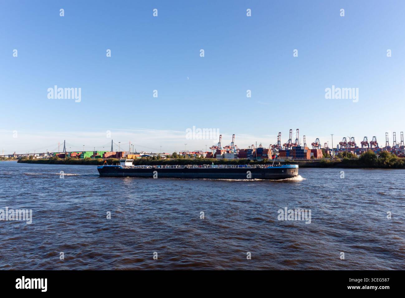 HAMBURG, GERMANY - AUGUST 12, 2024: A wide shot of a long, dark cargo ...