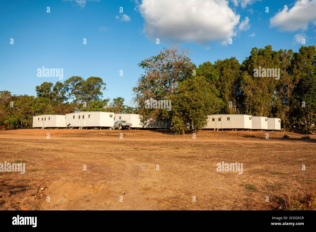 two long white demountables side by side trees infrastructure ...