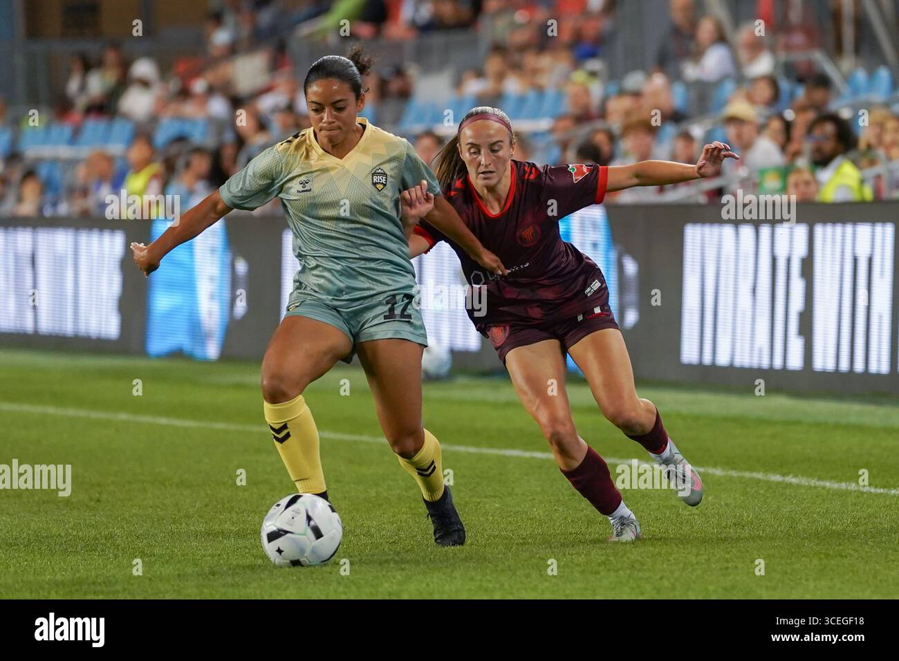 Lauren Rowe #77 of AFC Toronto and Jaylyn Wright #12 of Vancouver Rise FC battle for the ball ...