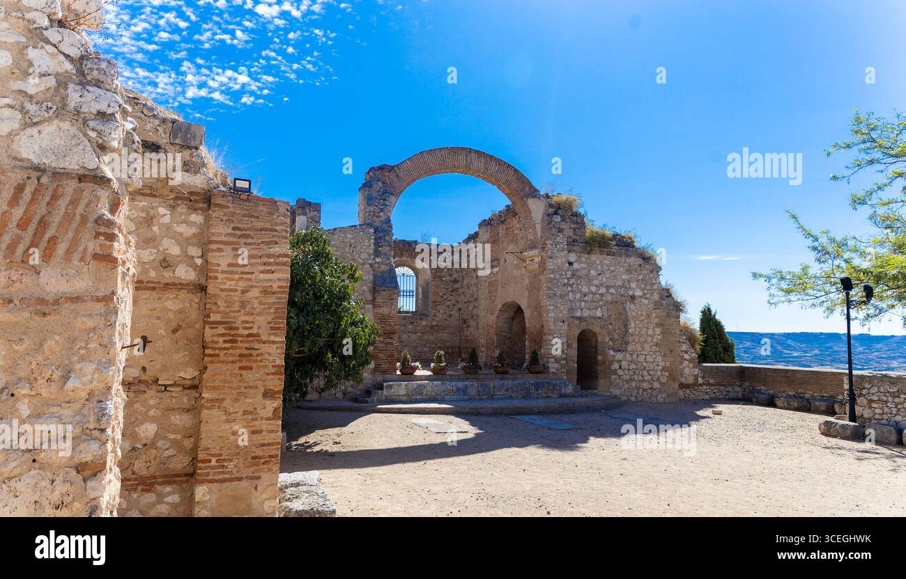 A large archway with a stone wall on either side. The archway is ...