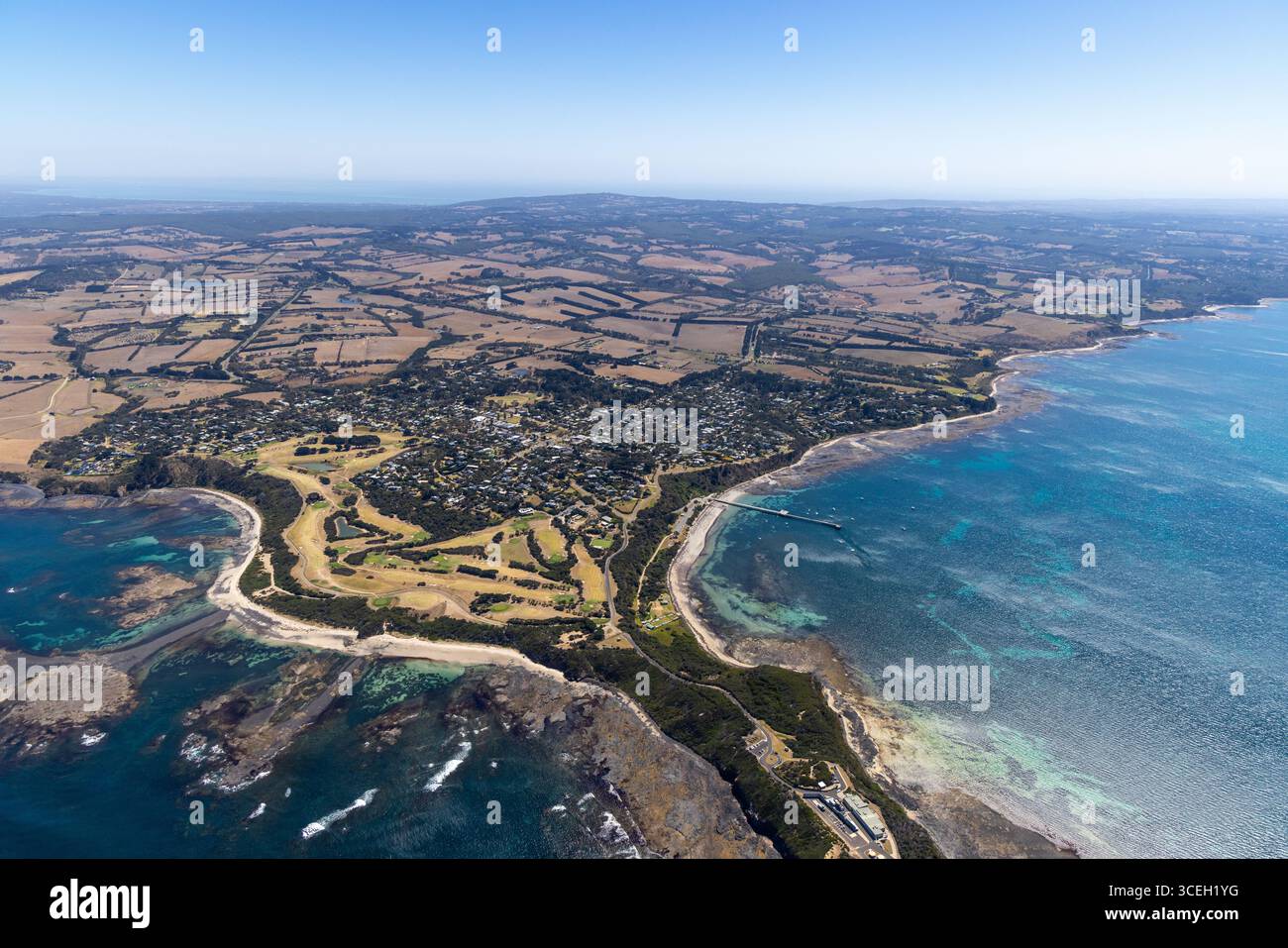 Aerial view of the rugged coastline meeting the serene blue waters ...